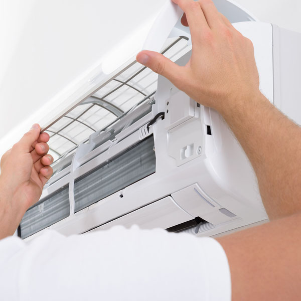Man Adjusting Air Conditioning System - The Aircon Doctor